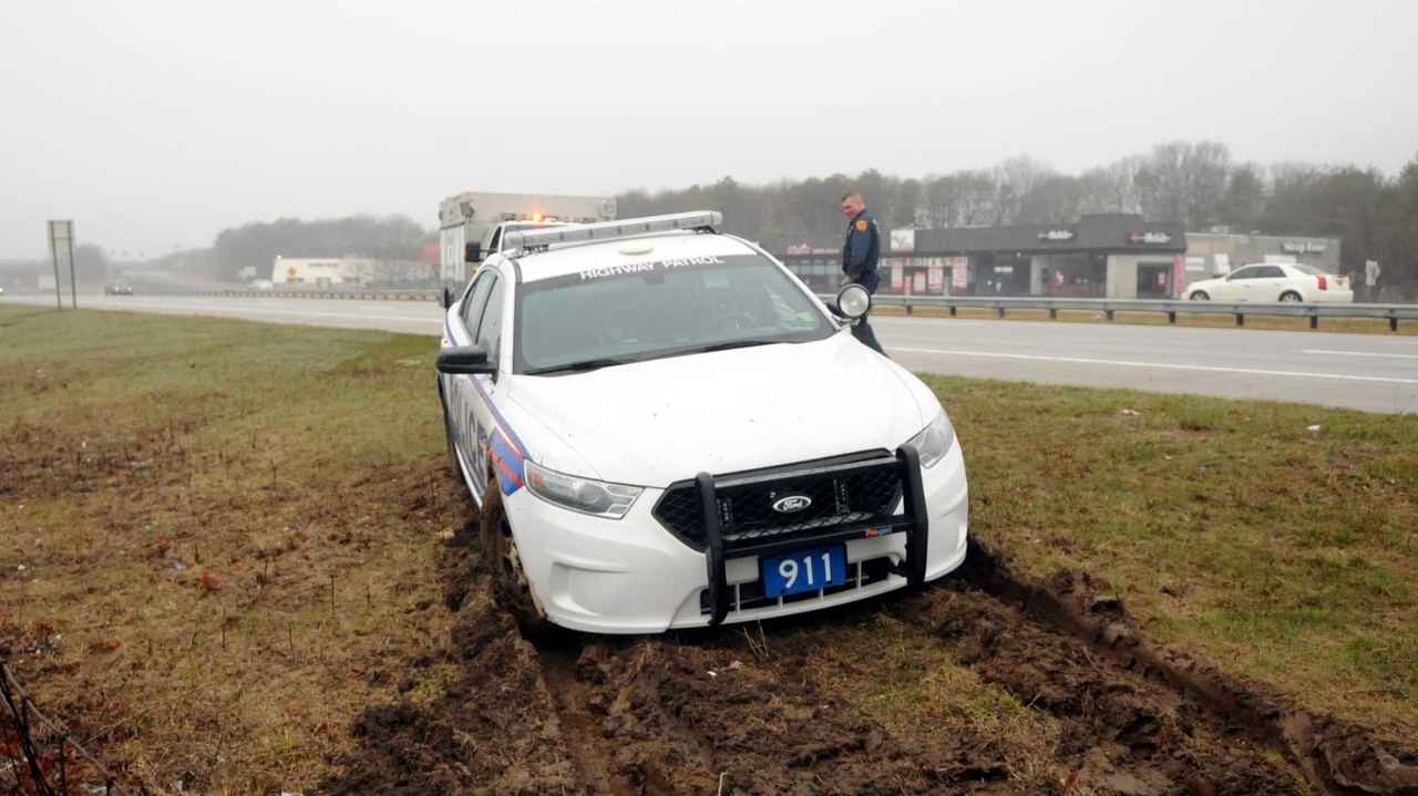 Suffolk cop car stuck in mud from heavy rains - Newsday