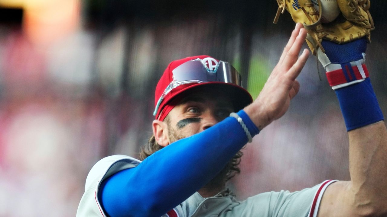 Phillies star Bryce Harper makes catch tumbling into photo pit in first ...