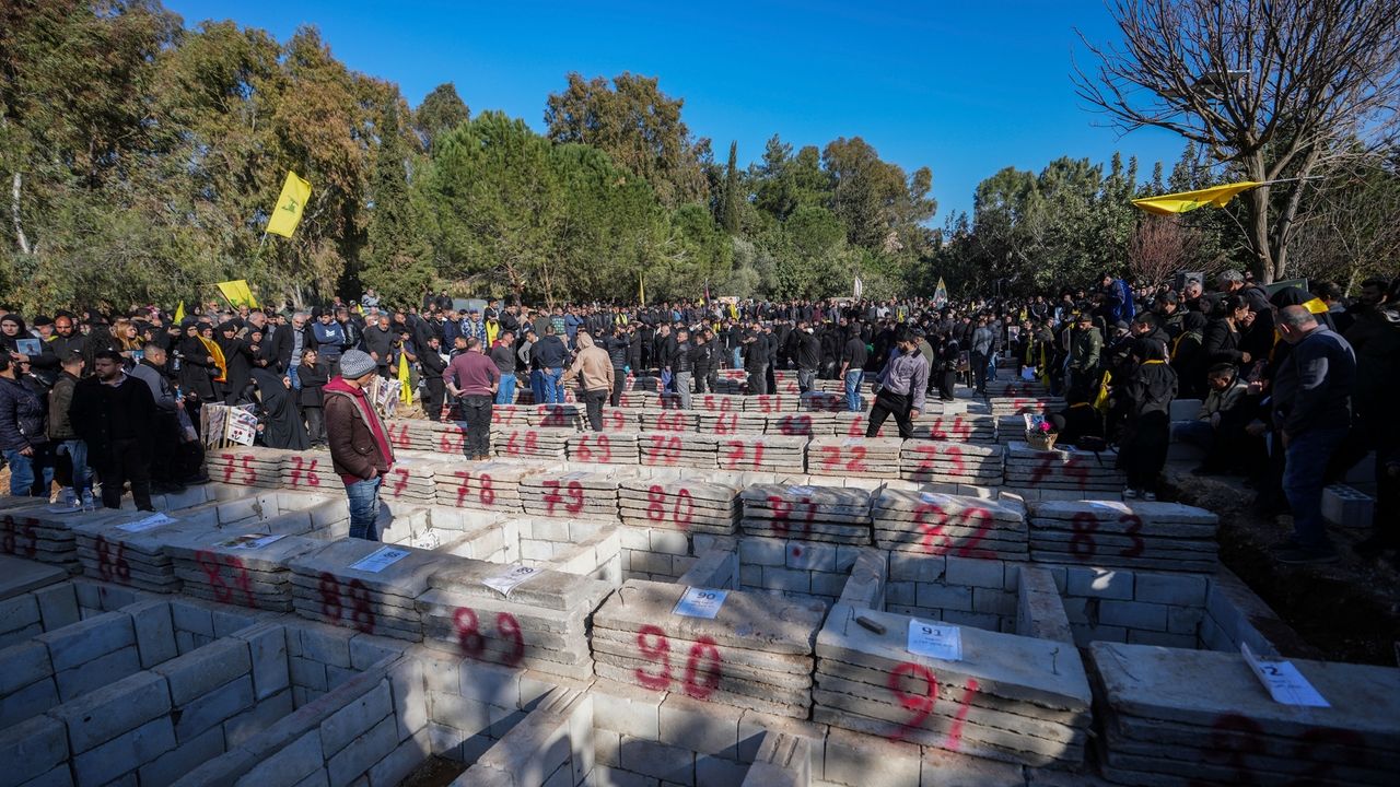 With flowers, tears and defiance, thousands bury nearly 100 Lebanese in ...