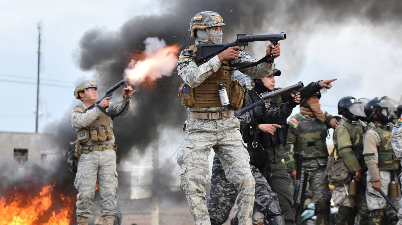 Protesters, police clash in Bolivia after president signs law enabling ...