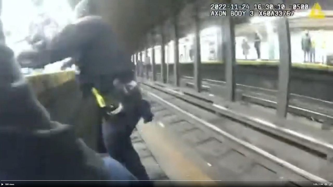 NYPD officers, bystander save man who fell onto subway tracks - Newsday