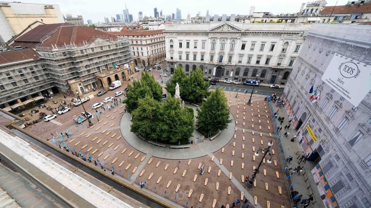 Mock coffins fill a square in Milan in a protest over workplace safety ...